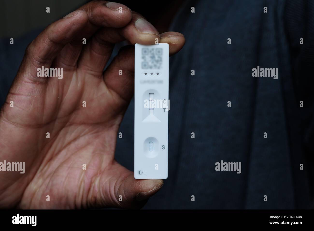 Person of African ethnicity holding a single positive Covid-19 rapid ...