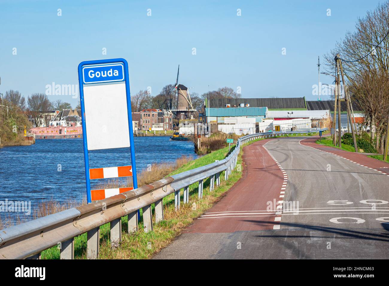 Scenic shore of river "Hollandsche IJssel" in Gouda, Holland ...