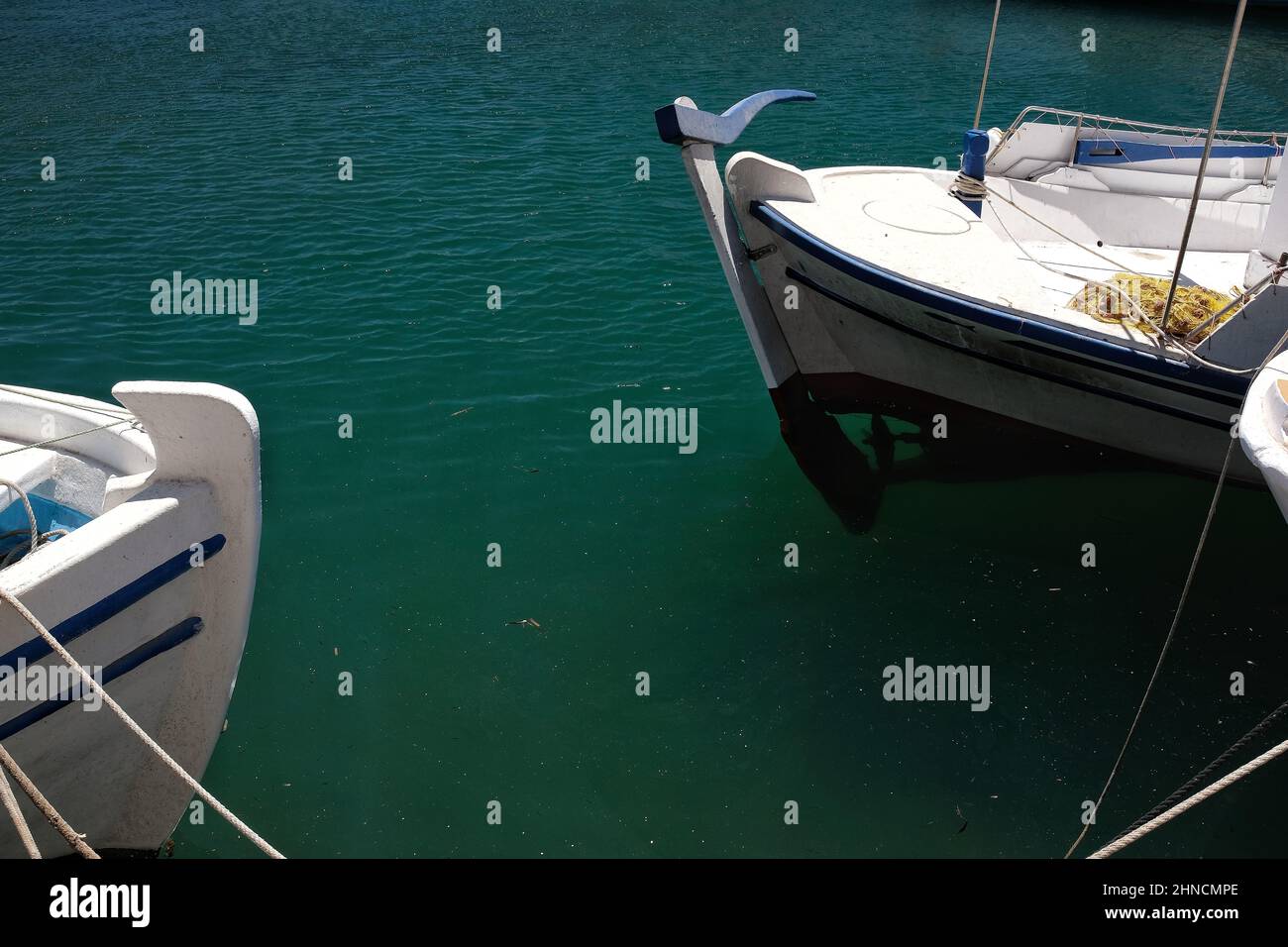 Two fish boat next to each other at the small port of Vlychada in ...