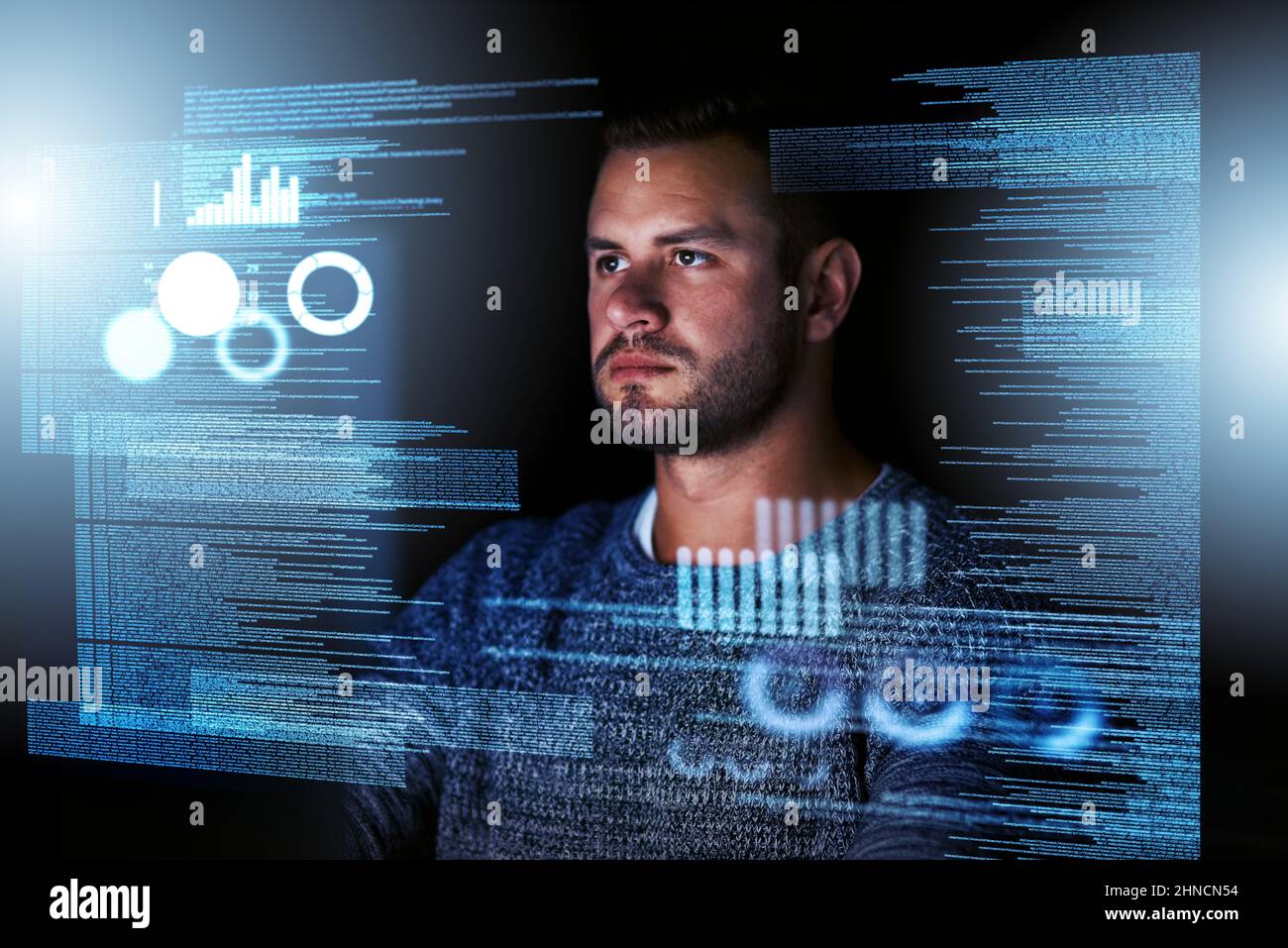 Hes technologically fluent. Shot of a focussed computer programmer working at his computer late ...