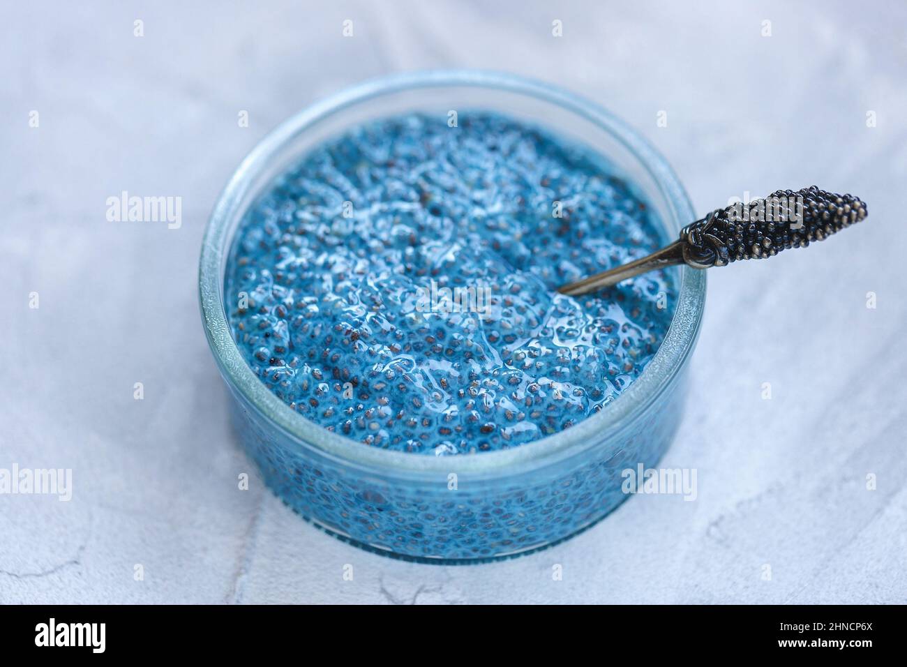 Blue spirulina chia seed pudding bowl with spoon. Superfood and vegan ...