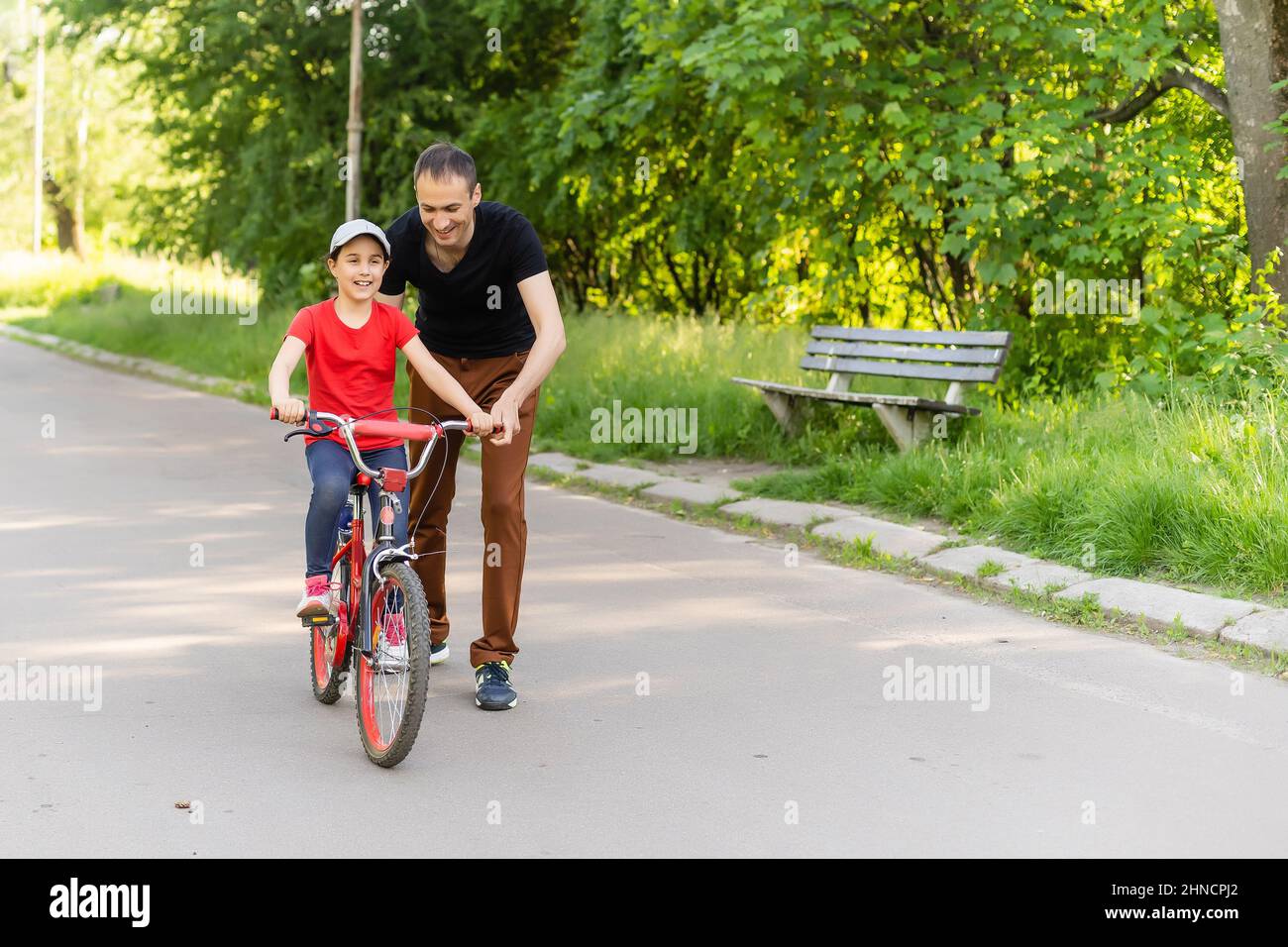 Girl learning to ride bike Stock Photo - Alamy