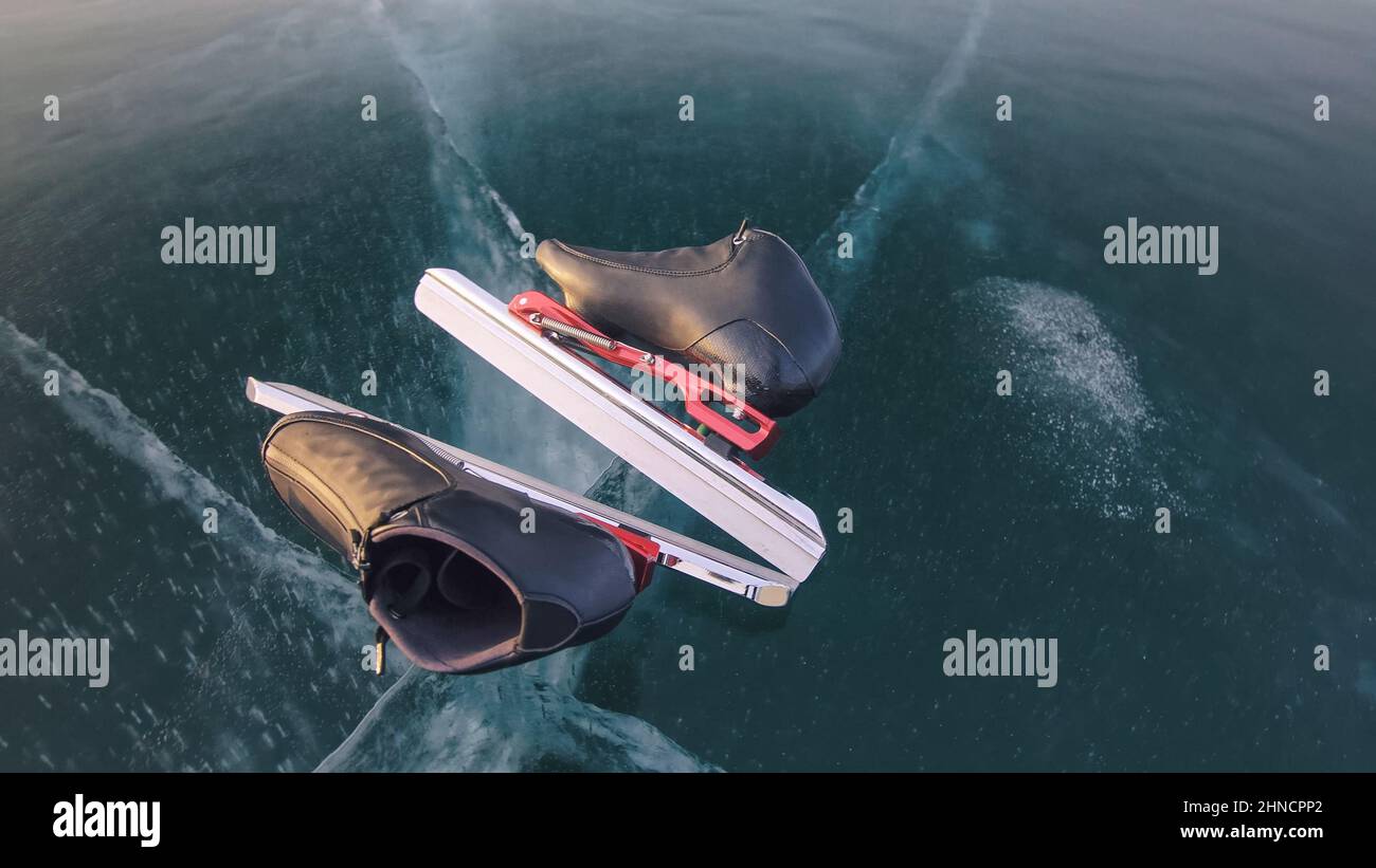 The skates boots are on the ice. The child train on ice speed skating ...