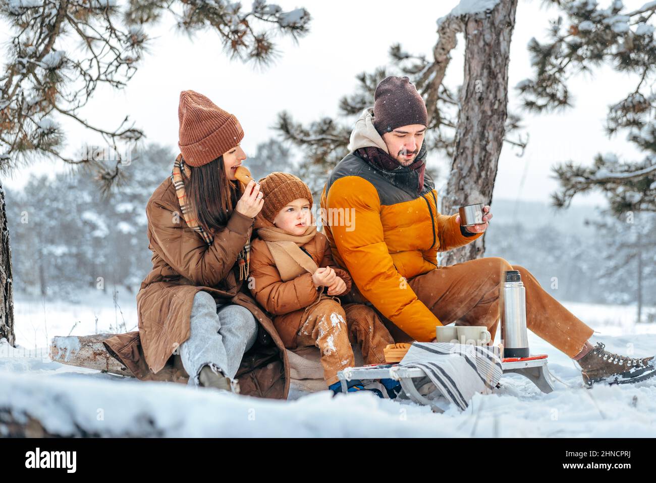 Happy family with cups of hot tea spending time together in winter ...