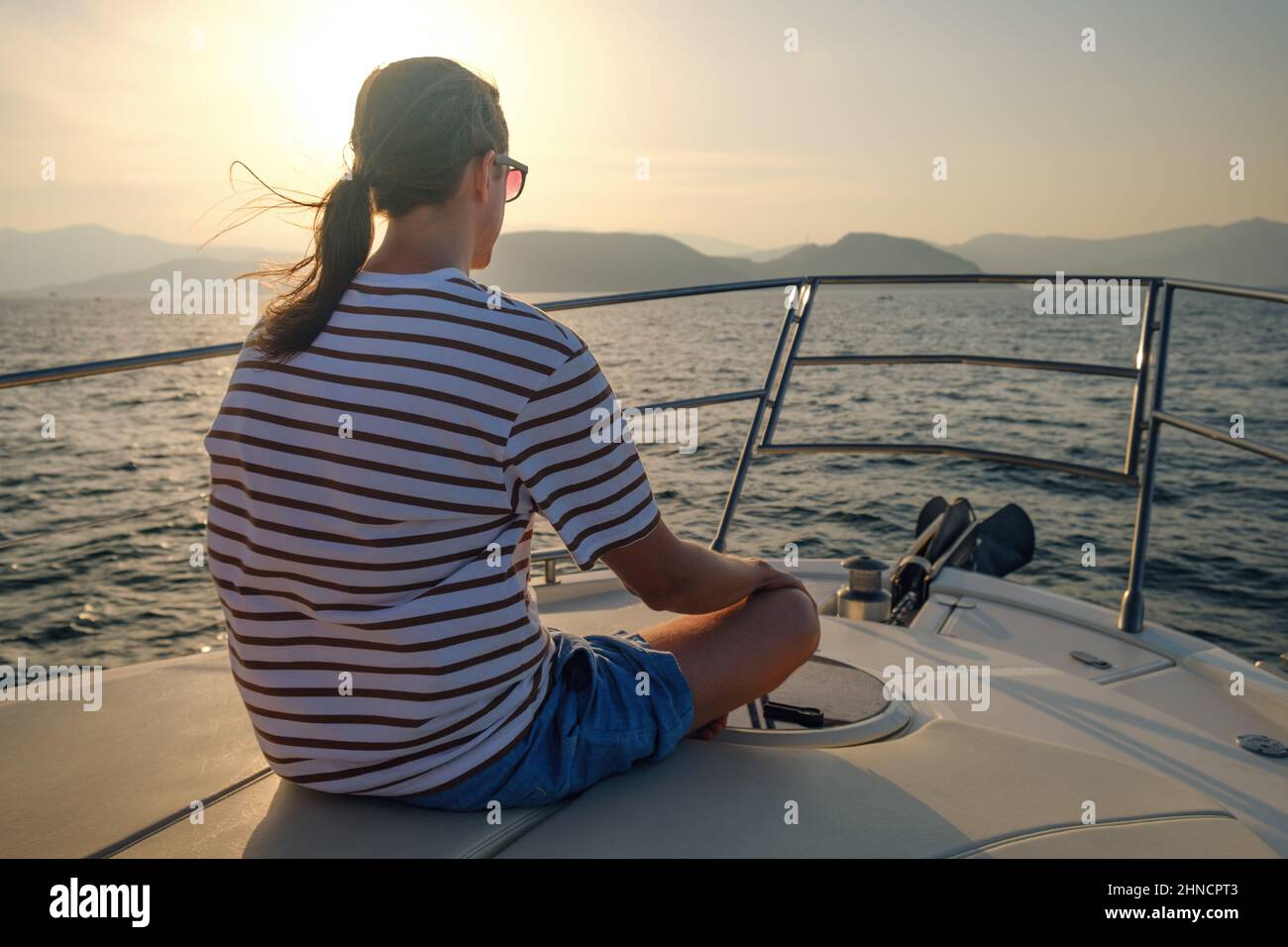 Young man sailing on luxury yacht at sunset Stock Photo - Alamy