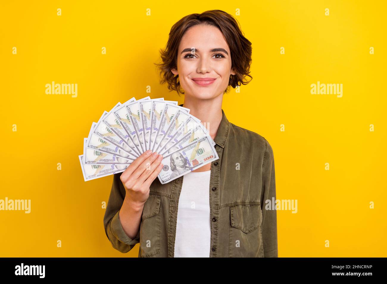 Photo of young pretty woman rich hold banknotes dollars income isolated ...