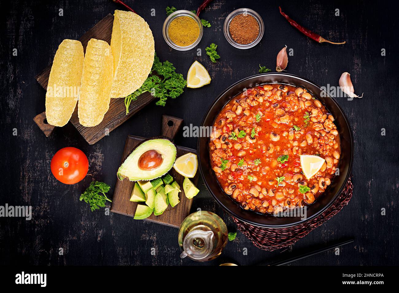 Chili con carne in bowl on dark background. Mexican cuisine. Top view ...