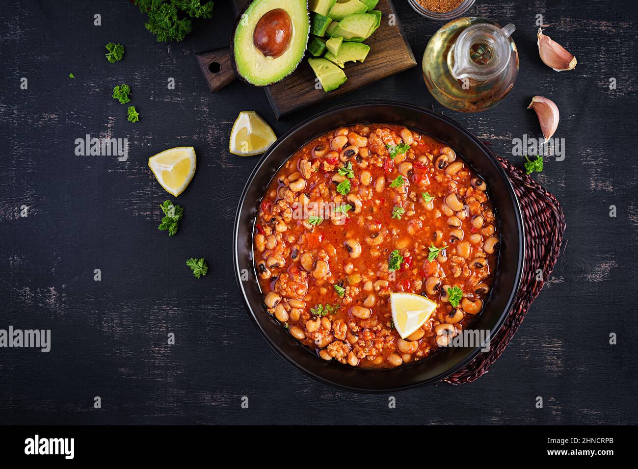 Chili con carne in bowl on dark background. Mexican cuisine. Top view ...