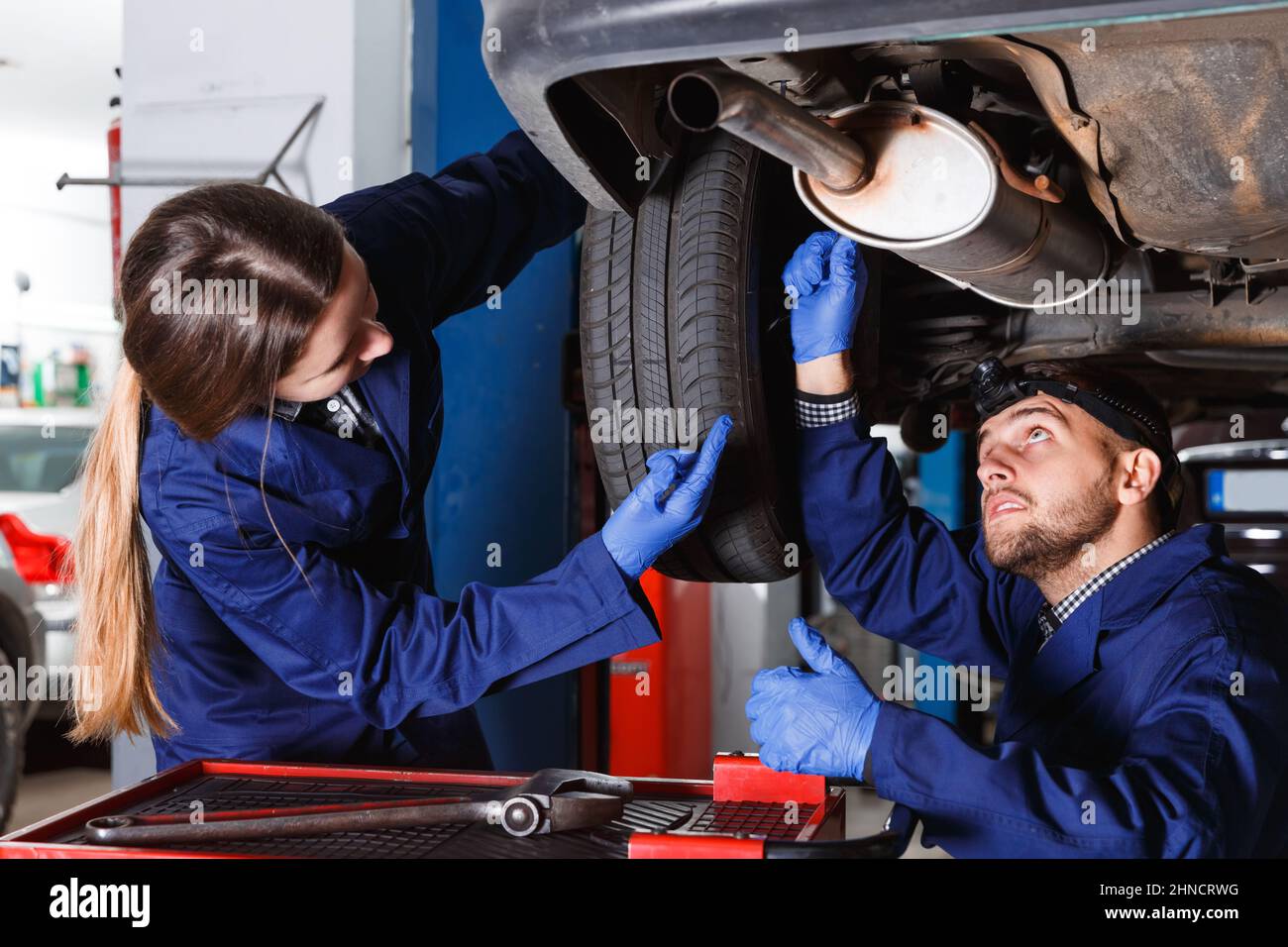 Two workers are repairing car on their workplace Stock Photo - Alamy