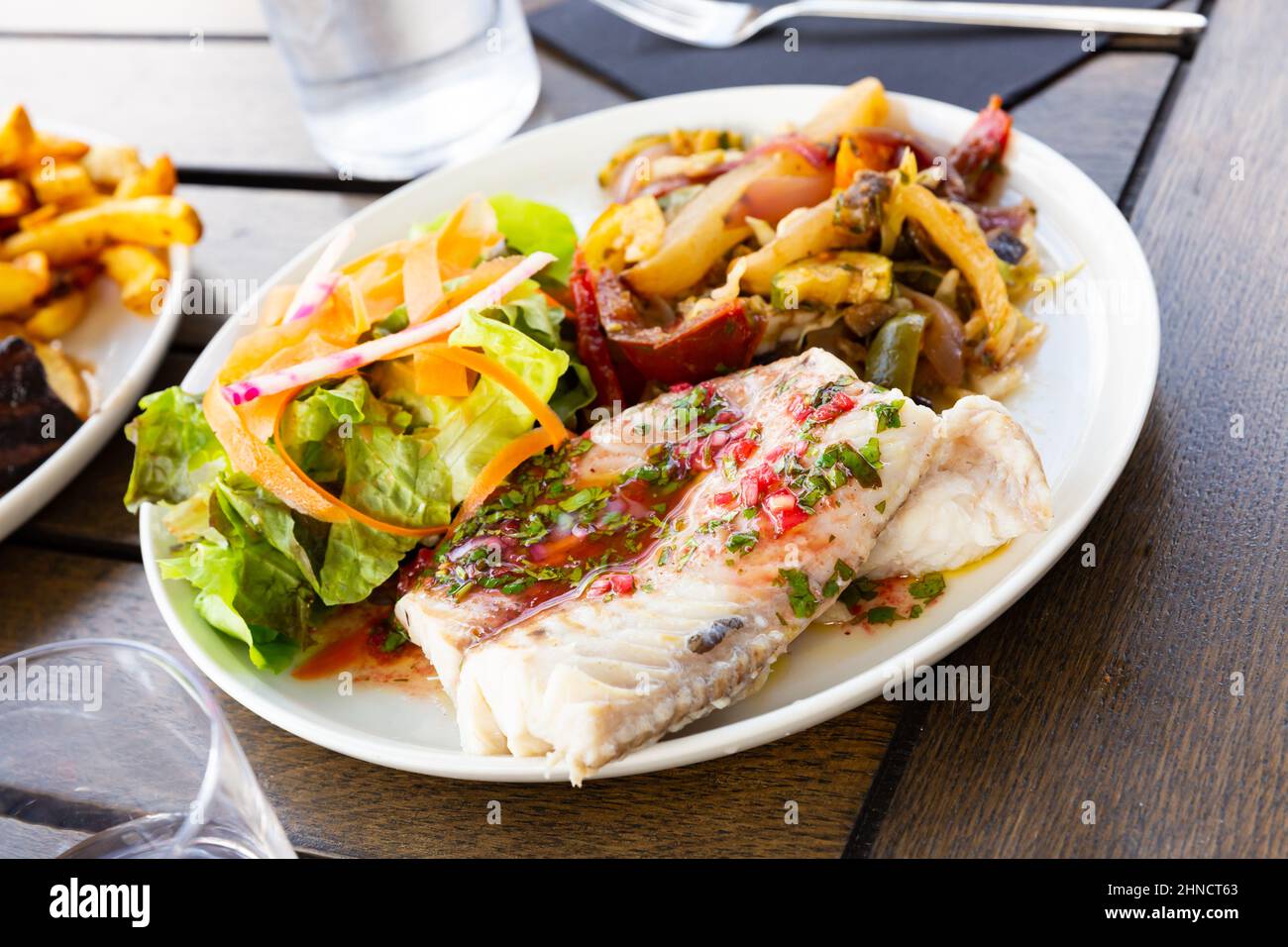 French-style molva or sea pike with vegetables Stock Photo - Alamy