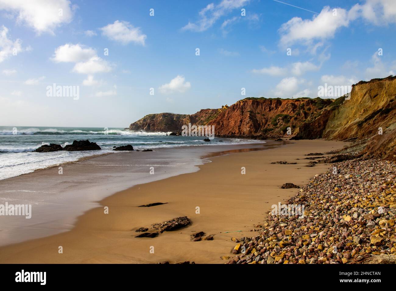 Beach with clear water and red cliffs in Algarve, Portugal Stock Photo ...