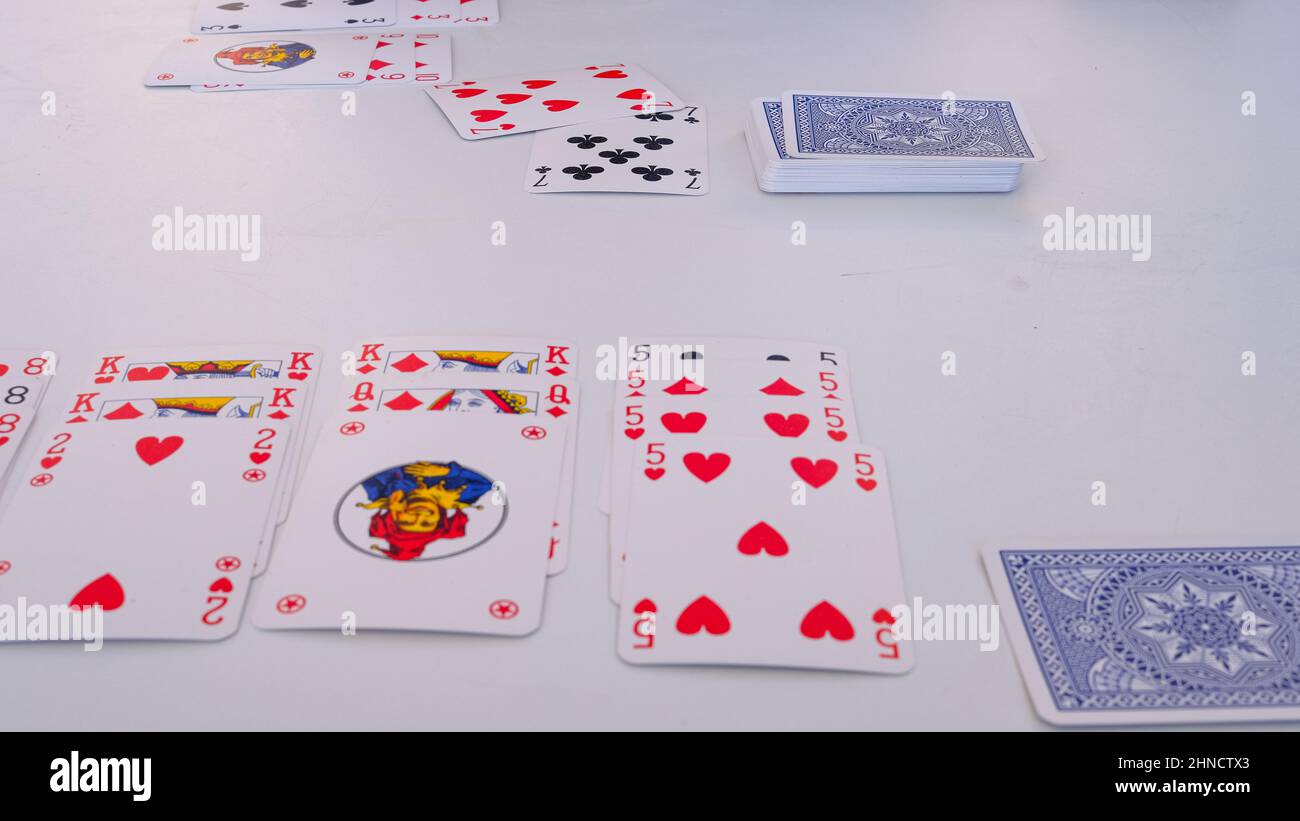 French cards on white table in game burraco Stock Photo - Alamy