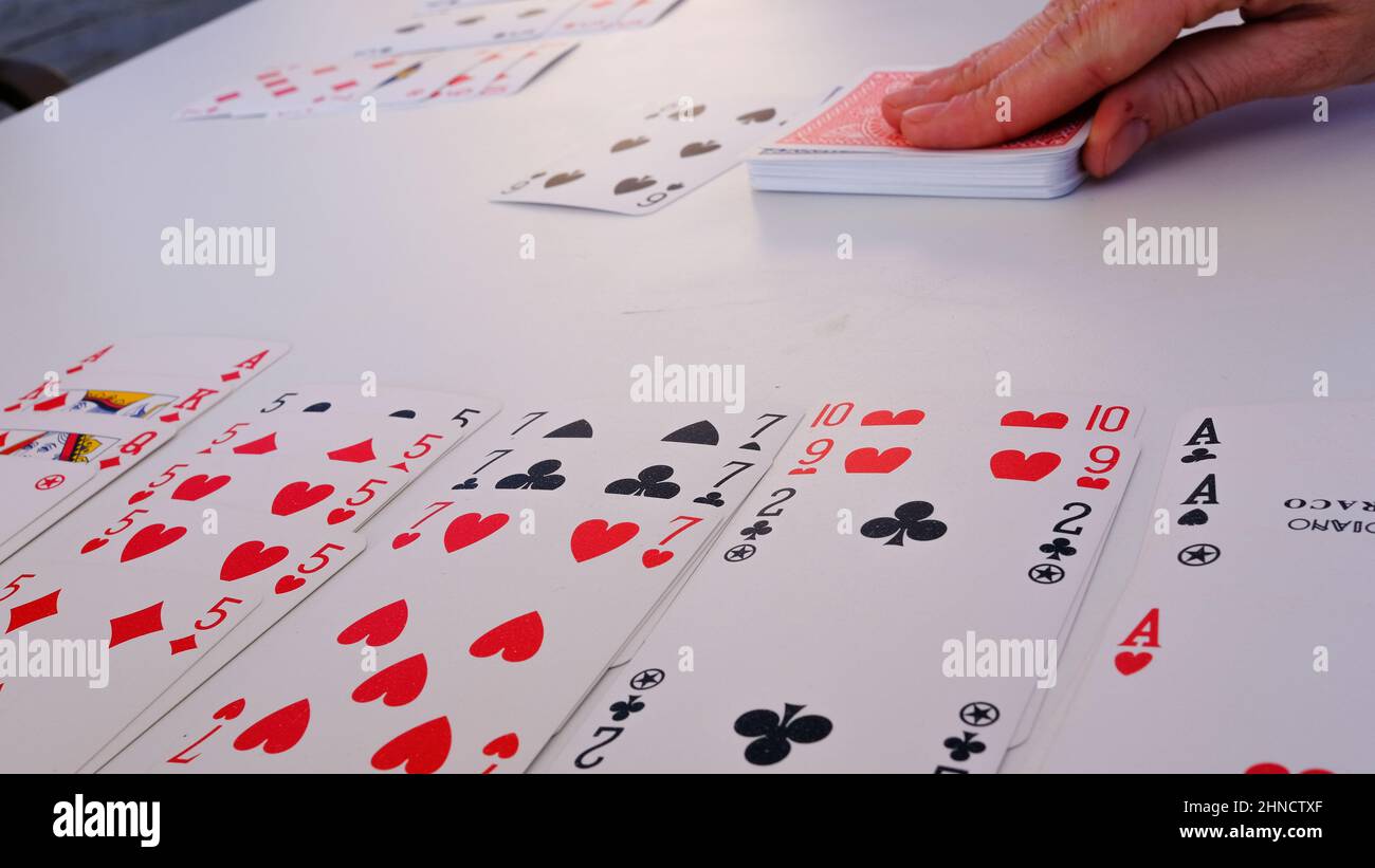 French cards on white table in game burraco Stock Photo - Alamy