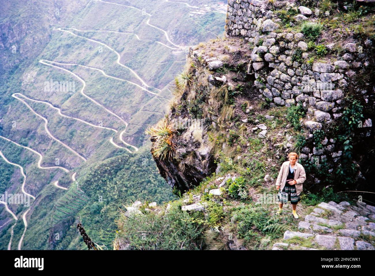 Female tourist walking up steep mountain path Huayna Picchu, Machu ...