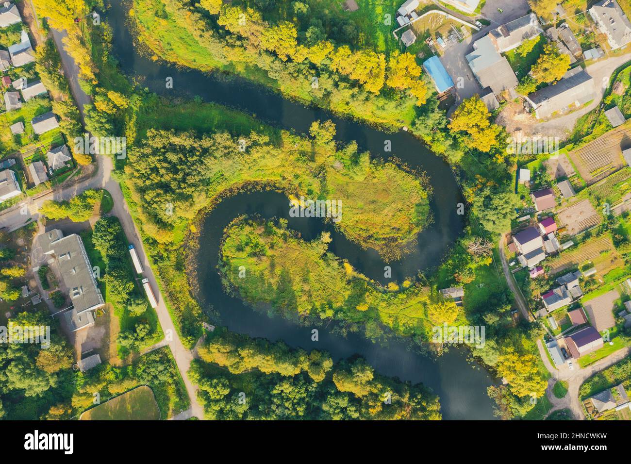 Top aerial view of the natural rural landscape valley of a meandering ...
