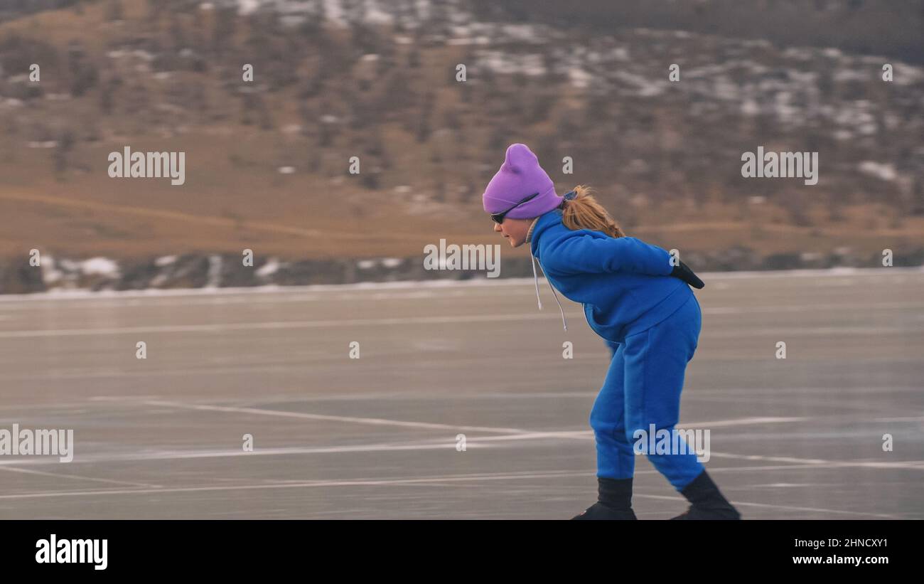 The child train on ice professional speed skating. The girl skates in ...