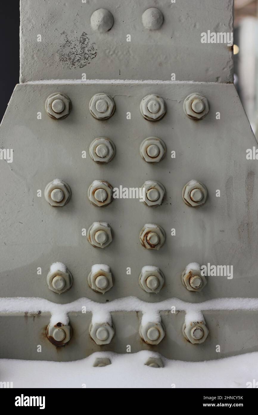 The nuts and bolts of an old worn weathered steel column constructed ...