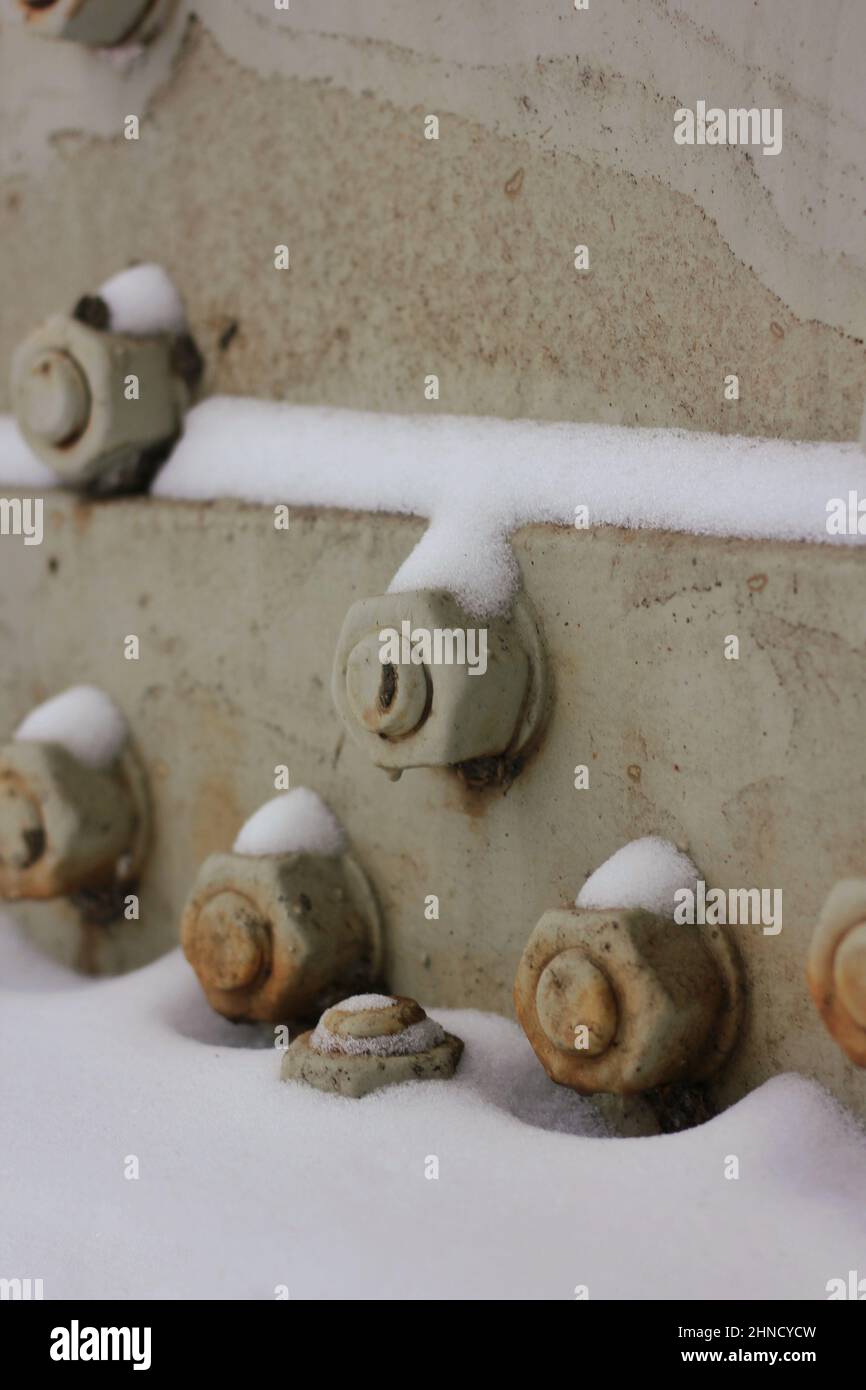 The nuts and bolts of an old worn weathered steel column constructed ...