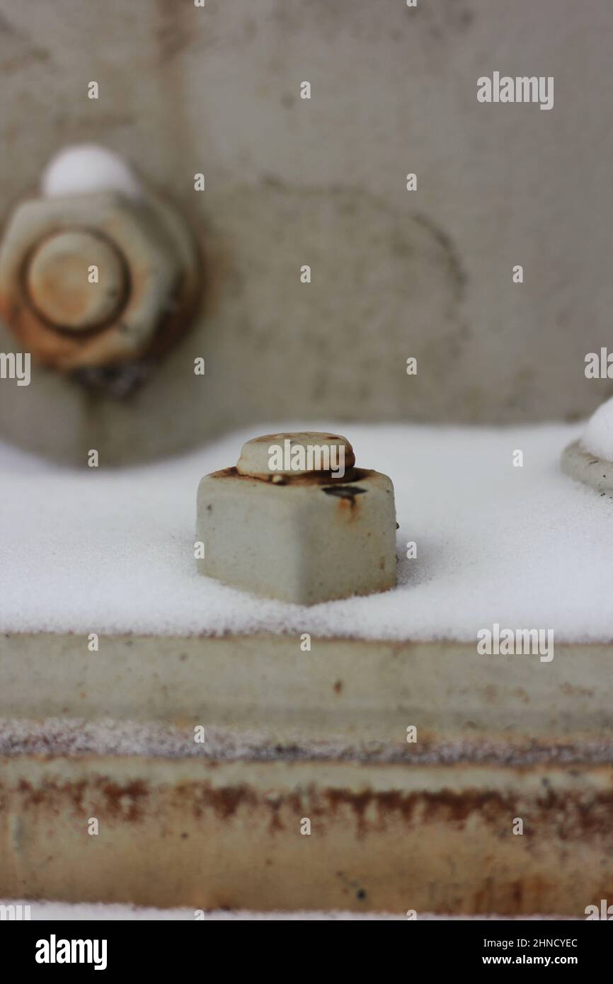 The nuts and bolts of an old worn weathered steel column constructed ...