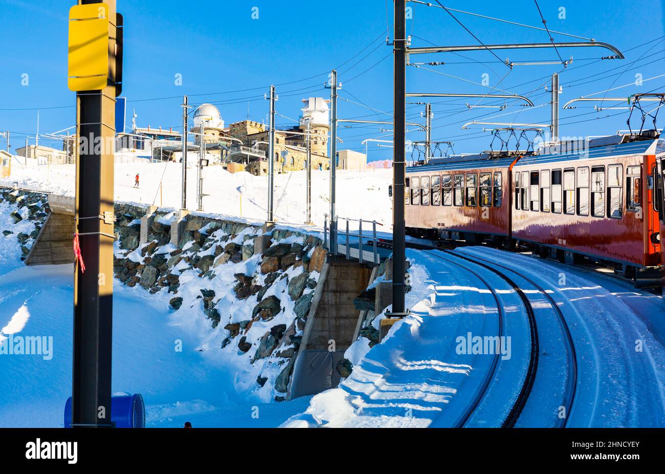 Red swiss train running through snow Stock Photo - Alamy