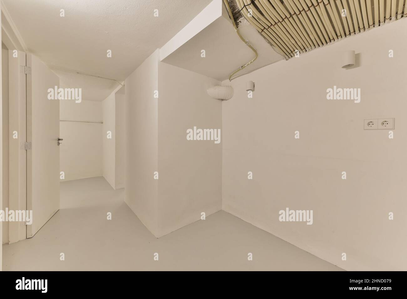 Interior of hallway with white walls and doors wires of home supply ...