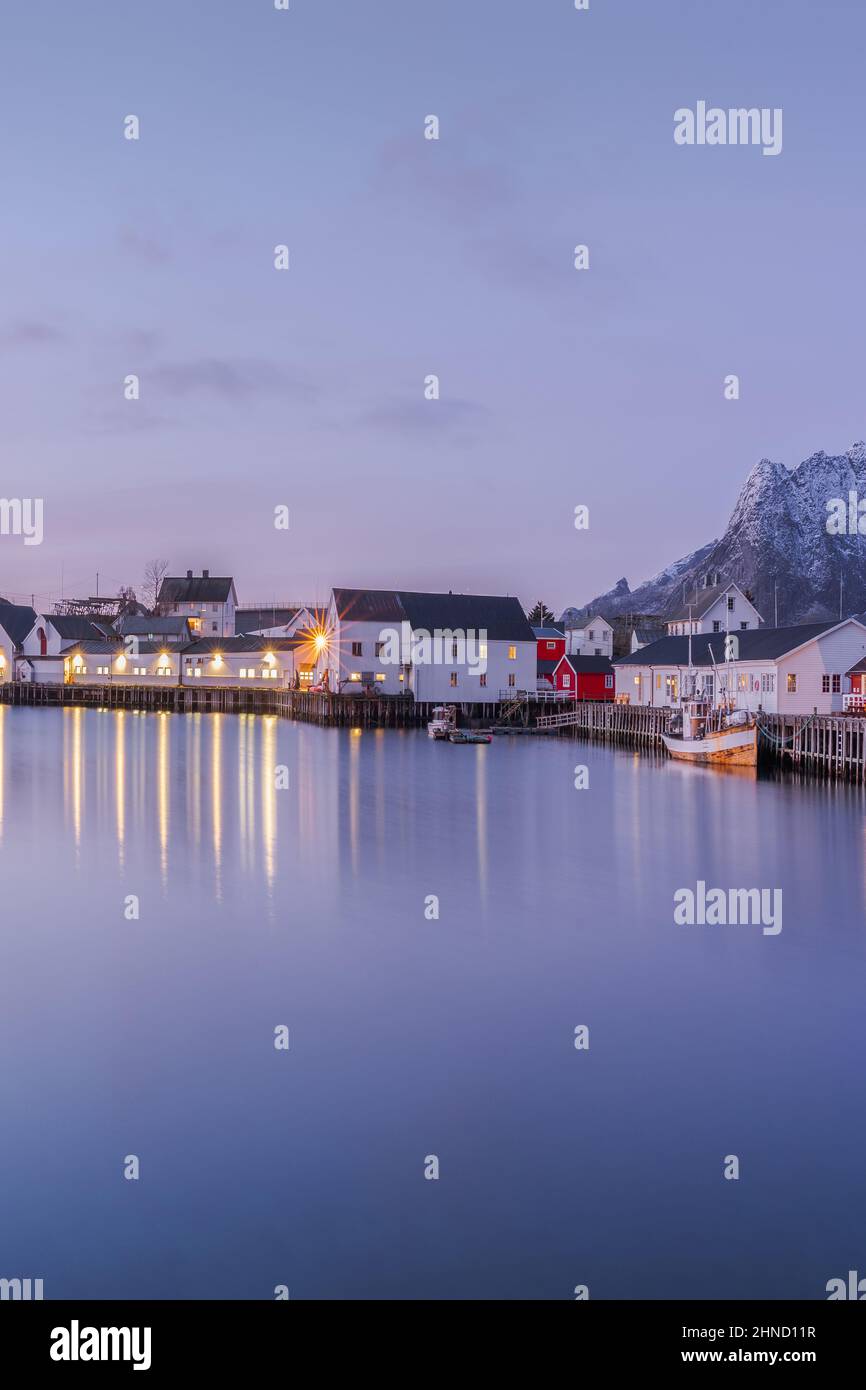 Amazing view of small vivid houses in village located on shore of calm ...