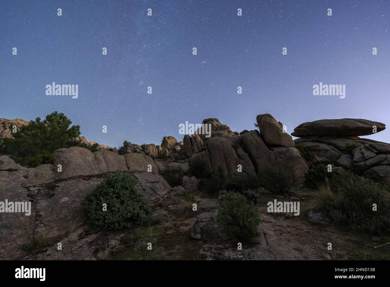 From below of magnificent landscape of rocks in highlands under starry ...