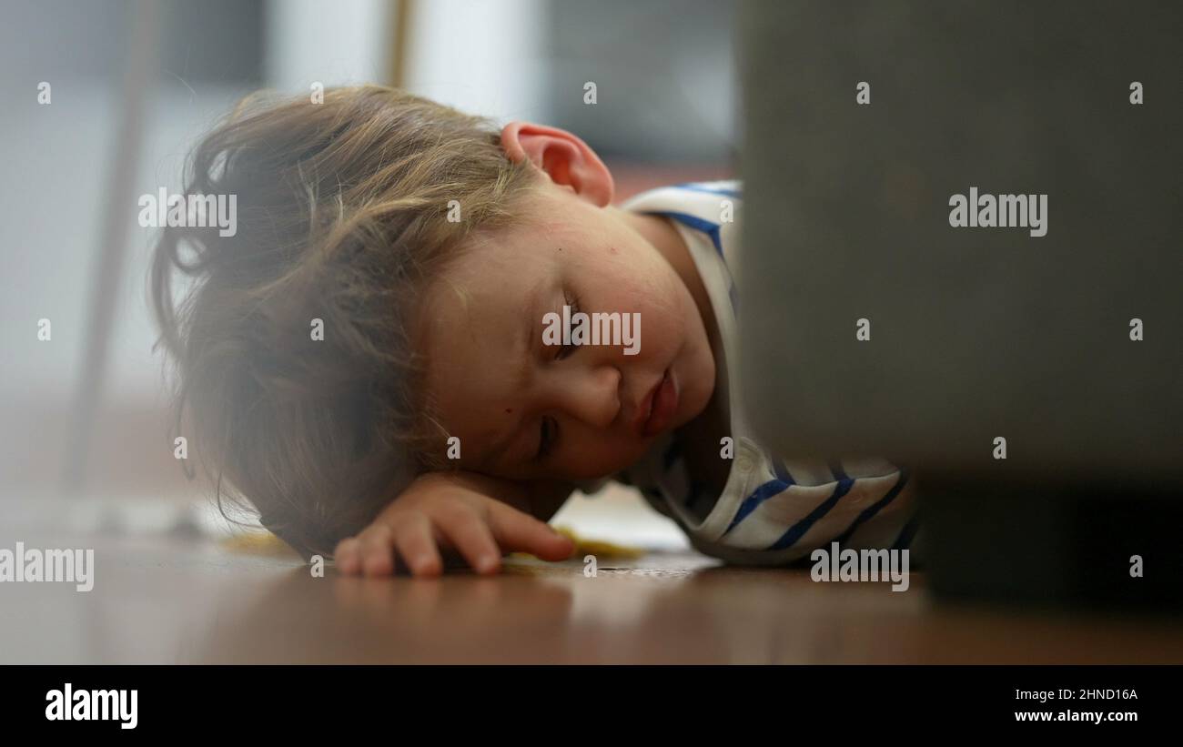 Angry little boy lying on floor feeling upset and boredom at home Stock ...