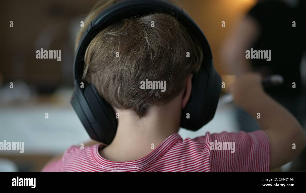 Back of child wearing headphones listening to audio Stock Photo - Alamy