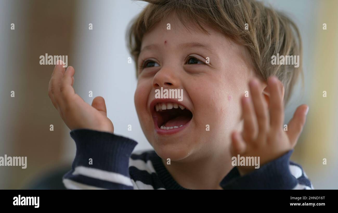 Adorable playful toddler playing peekaboo covering face with hands ...