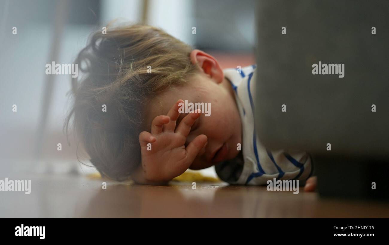 Angry little boy lying on floor feeling upset and boredom at home Stock ...
