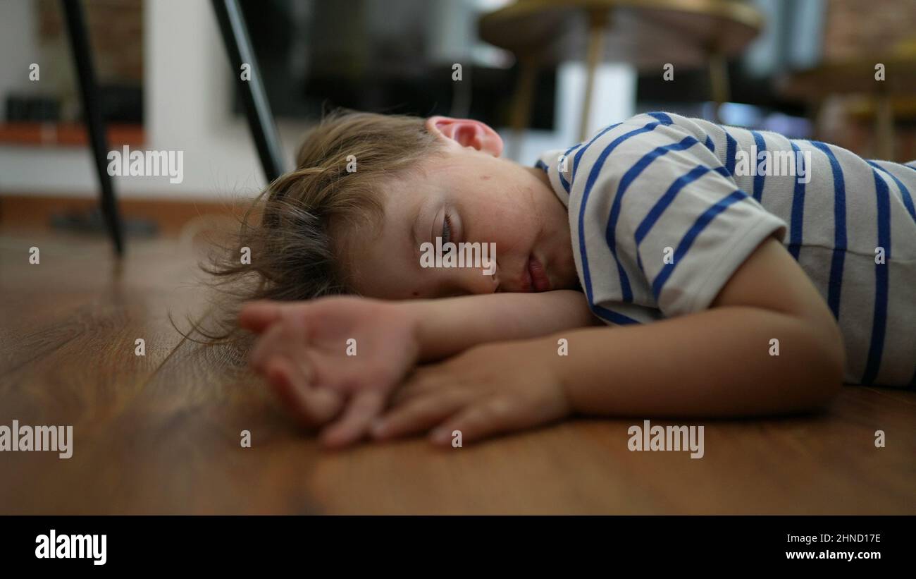 Bored kid Child feeling boredom lying on floor at home with nothing to ...