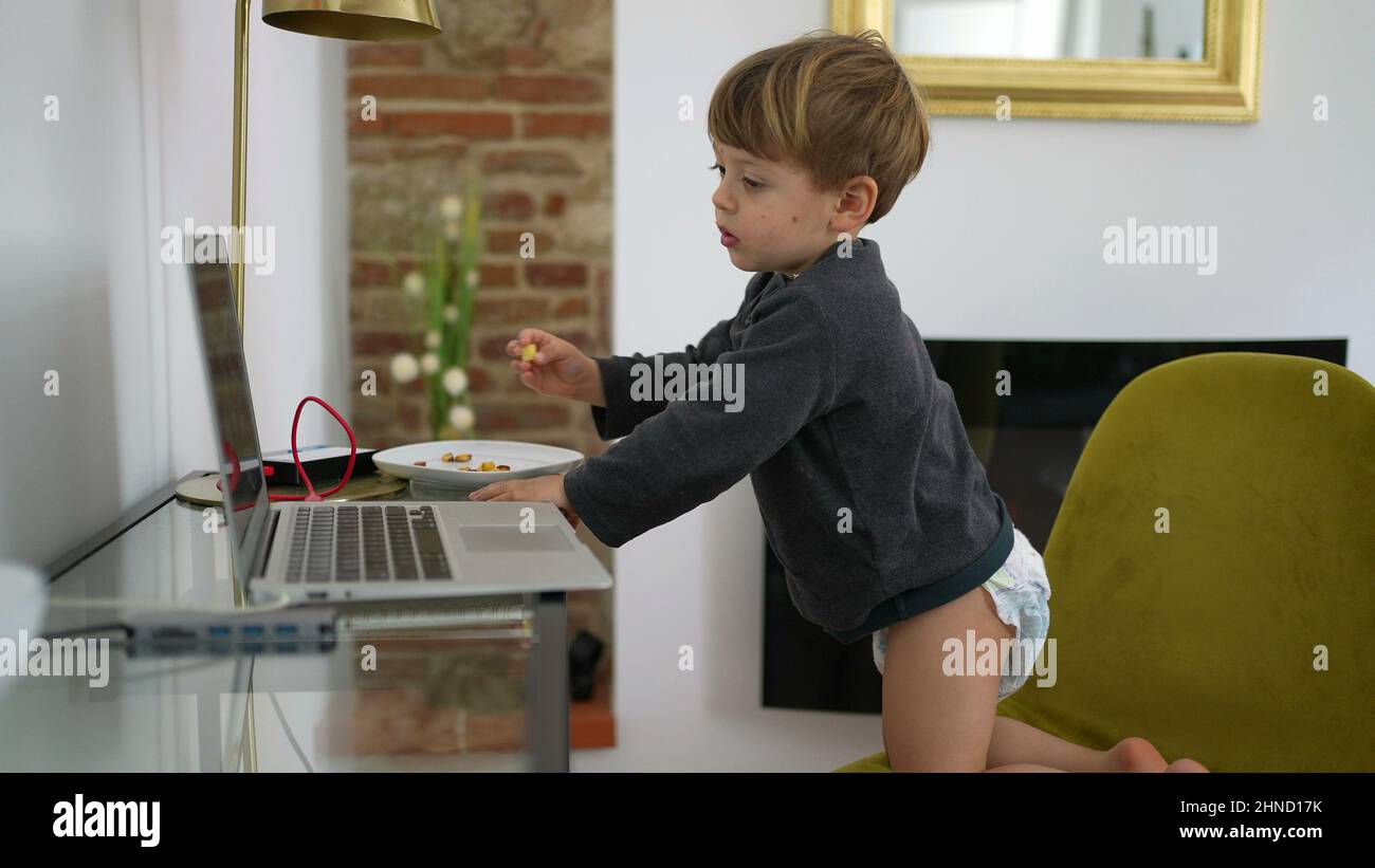 Baby boy wearing diapers in front of laptop at home 2 year old toddler ...
