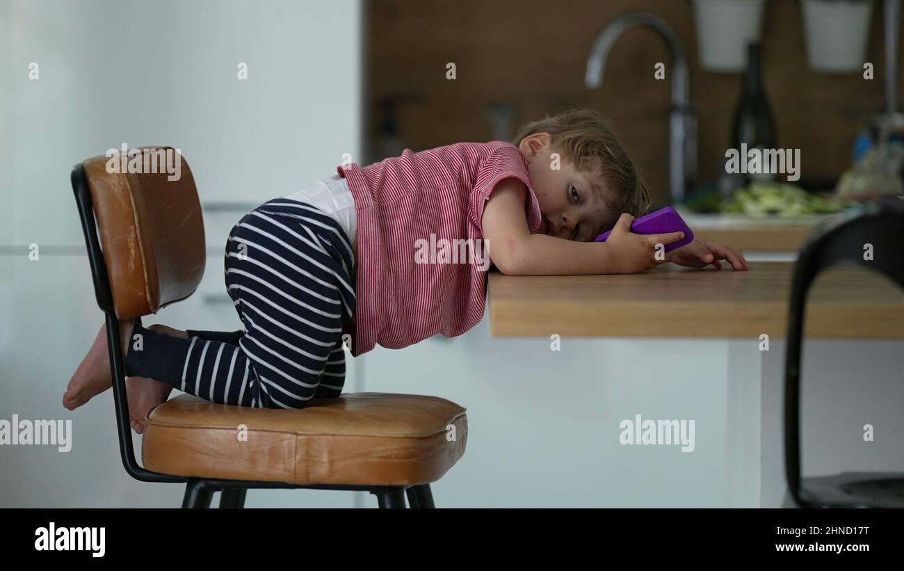 Bored little boy at home child boredom Stock Photo - Alamy