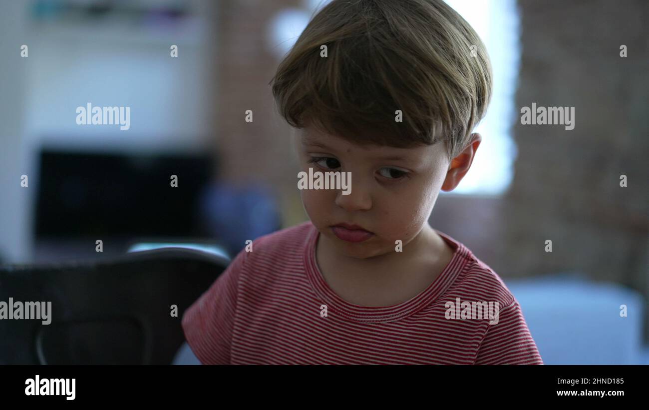 Bored pensive little boy portrait face close-up child feeling boredom ...