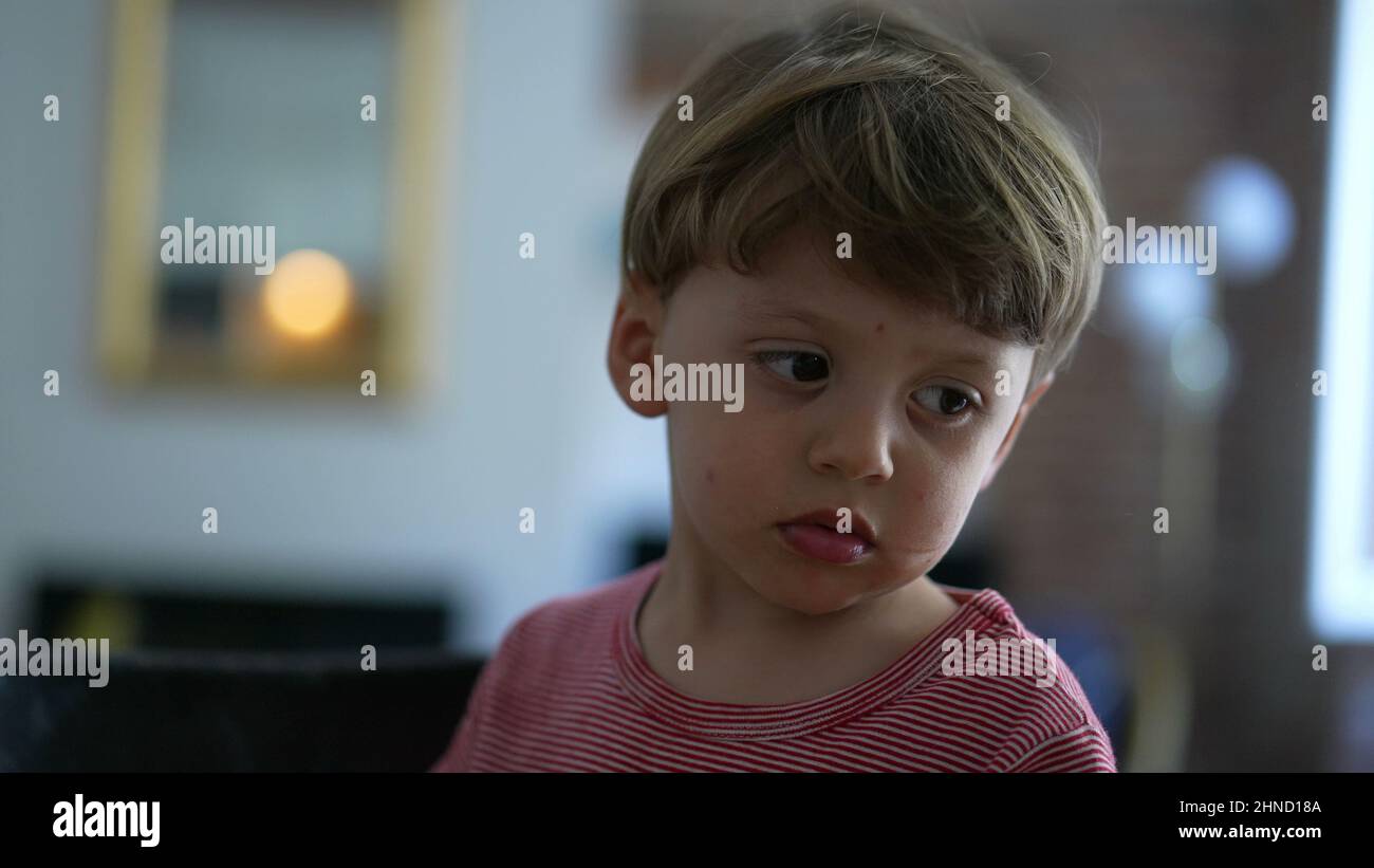 Bored pensive little boy portrait face close-up child feeling boredom ...