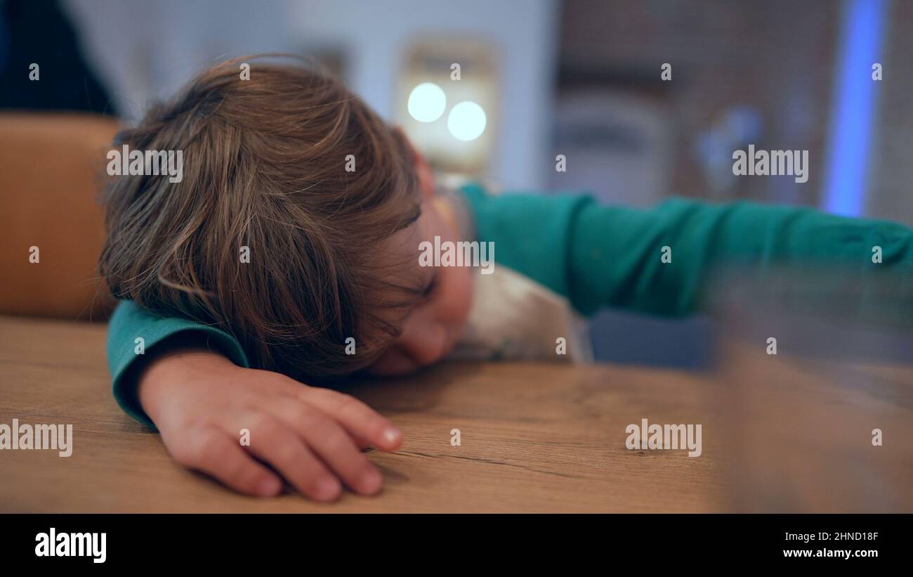 Bored little boy lying on floor at home child having nothing to do ...