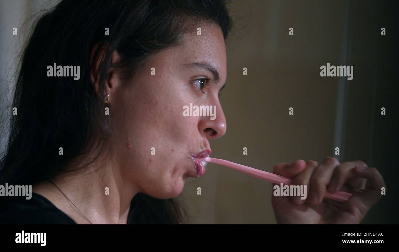 Woman brushing teeth at night routine Stock Photo - Alamy