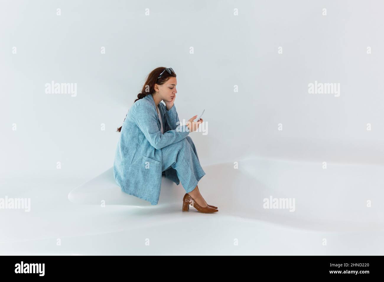 Side view of full body of content female in elegant wear scrolling ...