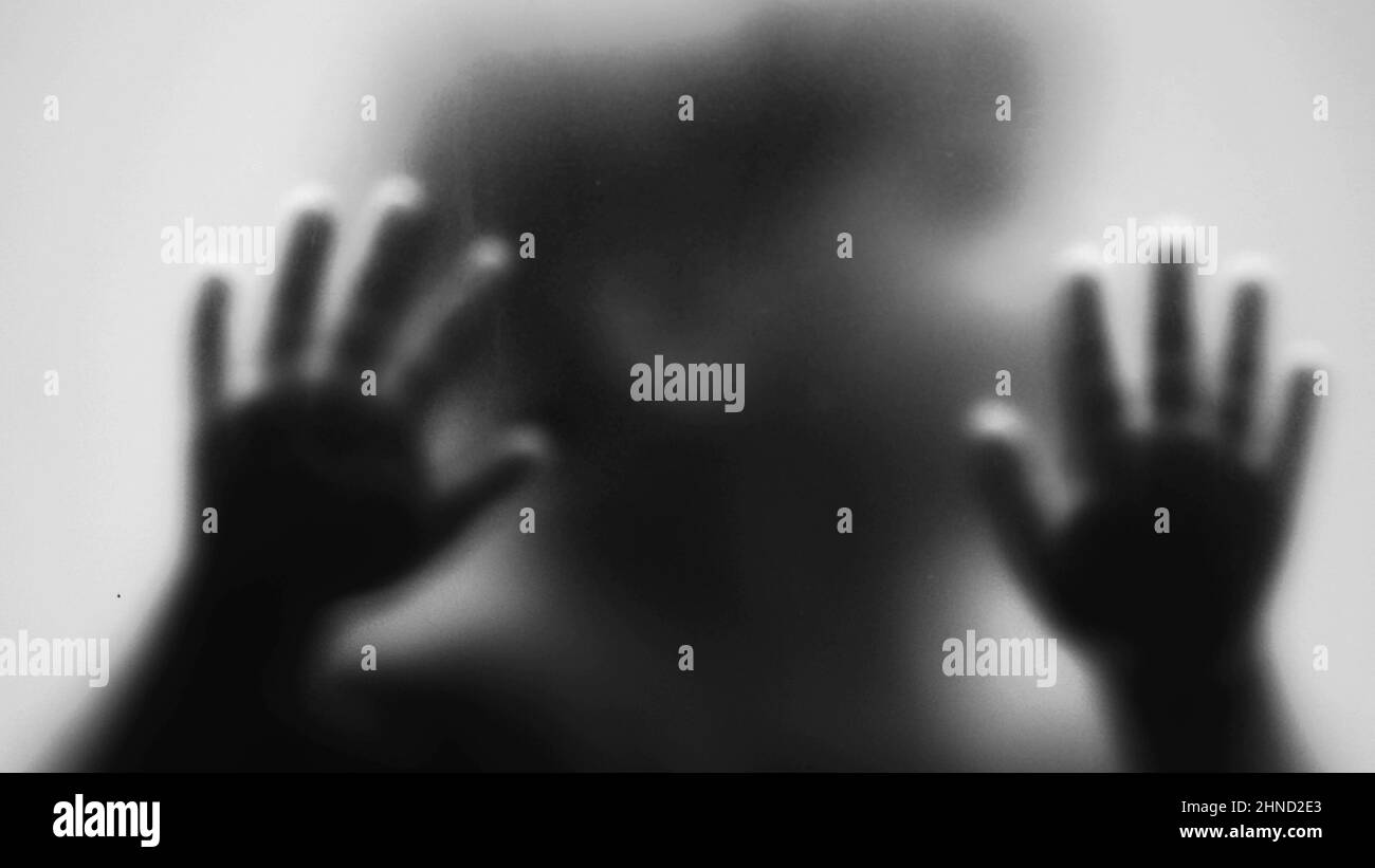 Child behind the matte glass blurry hand and body soft focus in ...