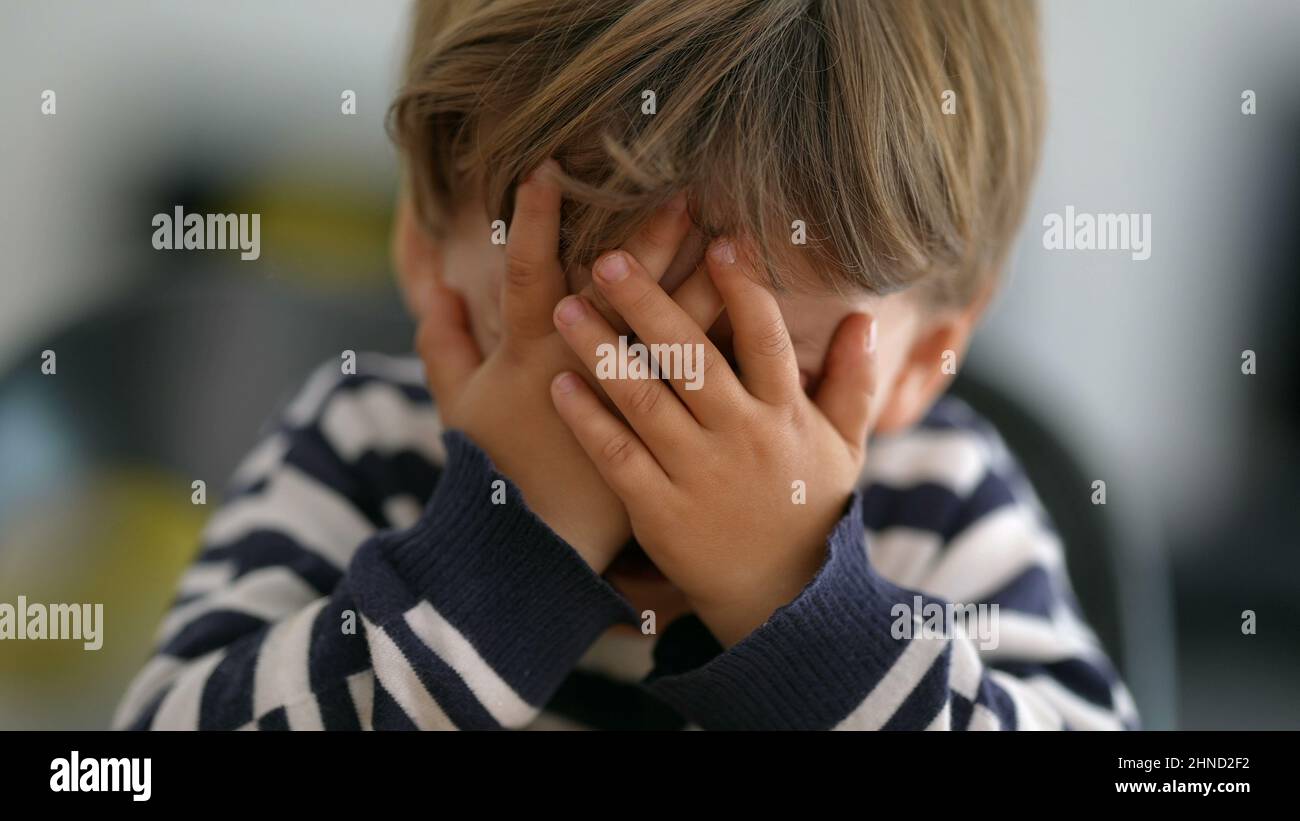 Child covering face with hands OH no Stock Photo - Alamy