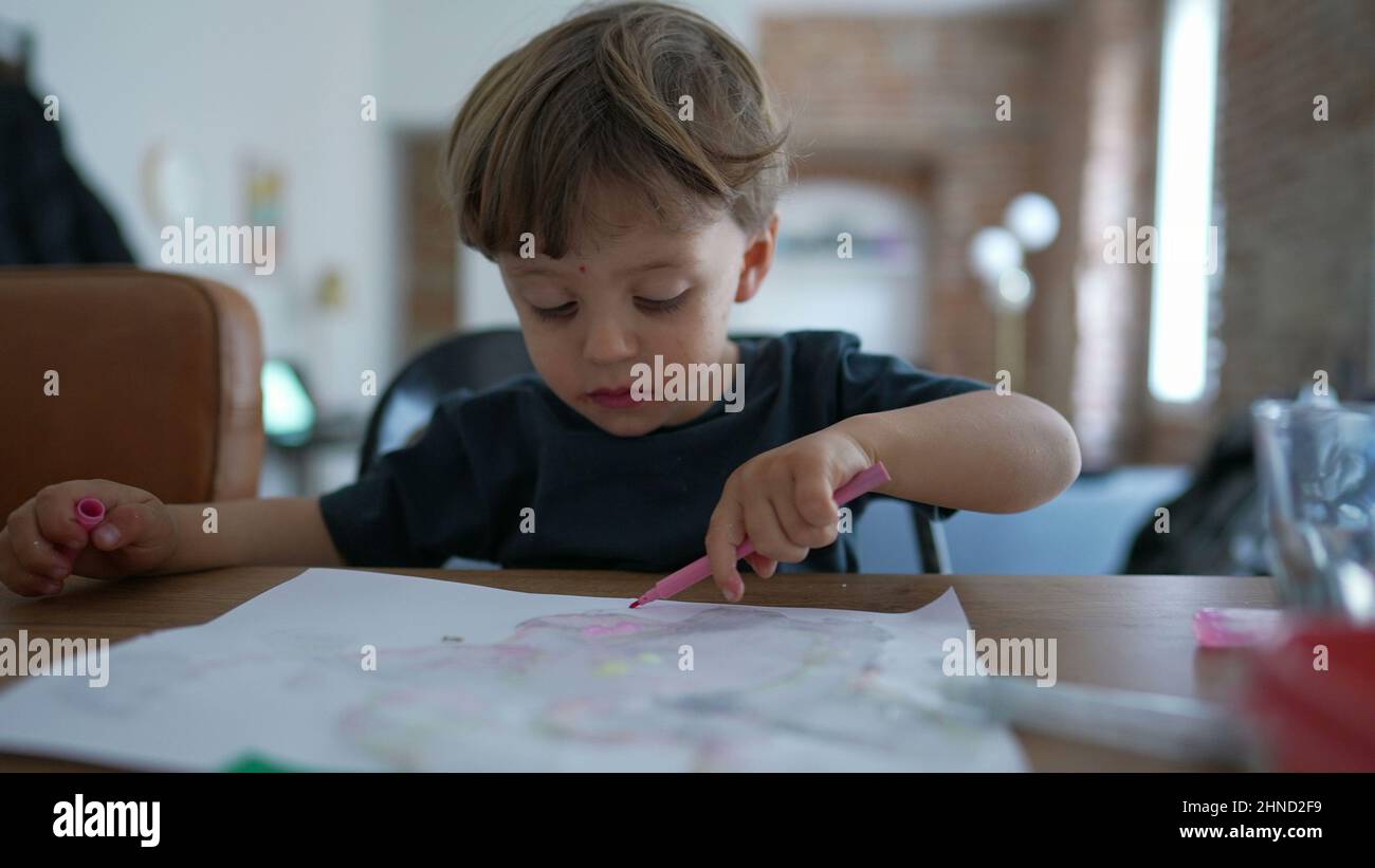 Child drawing with color pen on paper Little boy playing art and craft ...