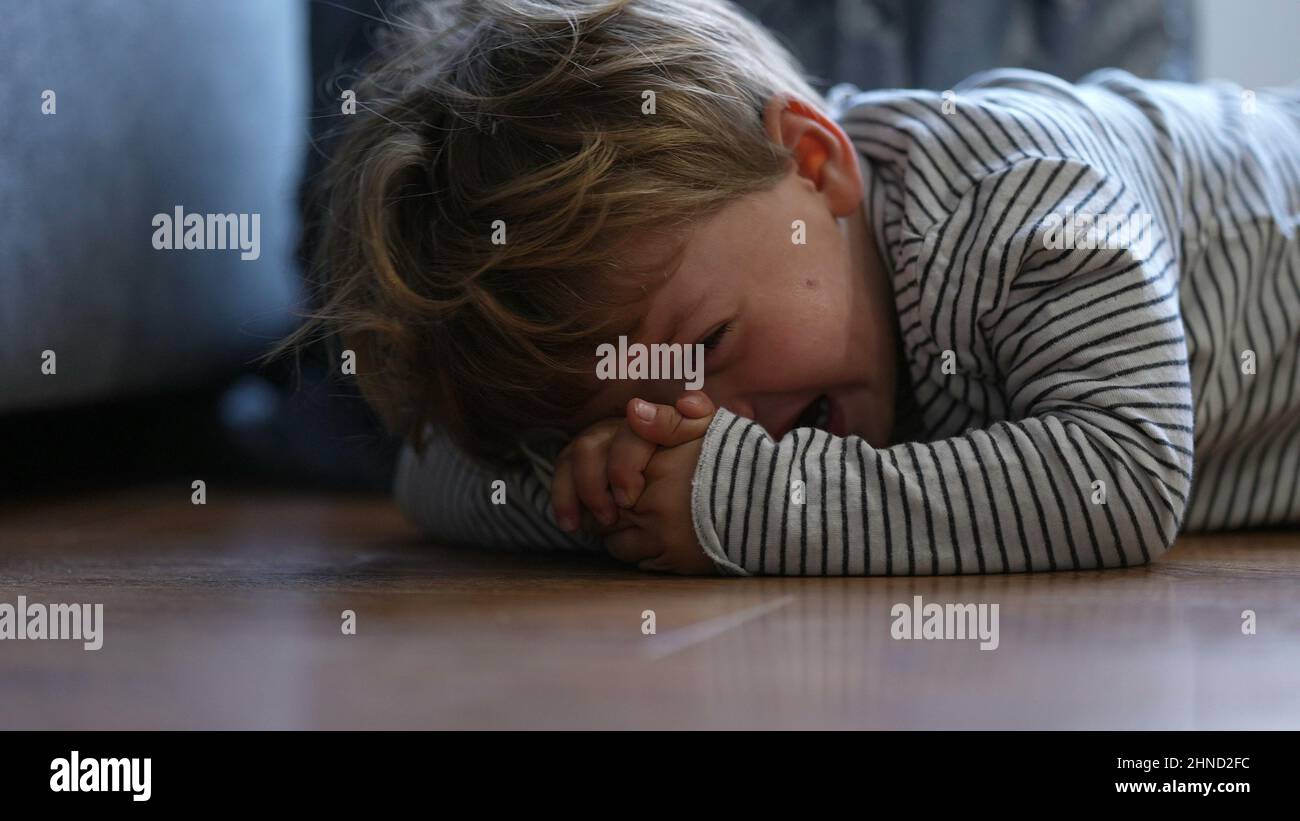 Child crying on floor having tantrum little boy cries Stock Photo - Alamy