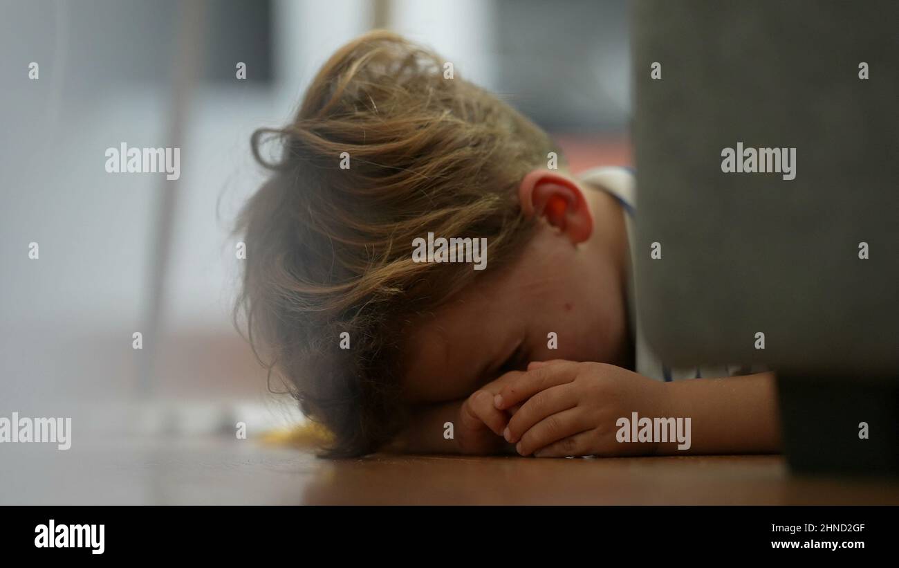 Child feeling boredom at home upset bored kid at home lying on floor ...