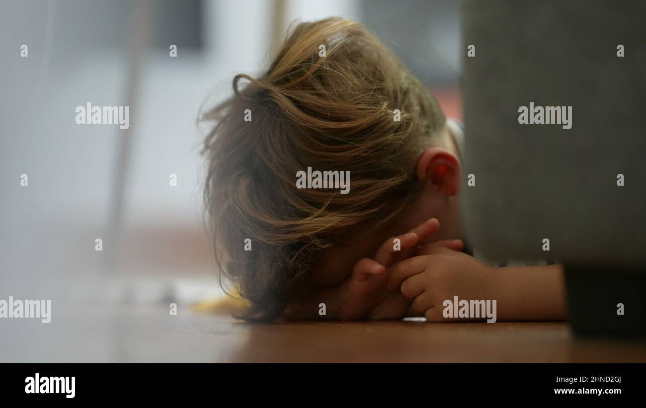 Child feeling boredom at home upset bored kid at home lying on floor ...