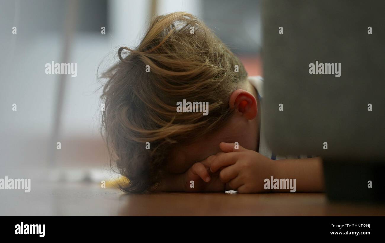 Child feeling boredom at home upset bored kid at home lying on floor ...