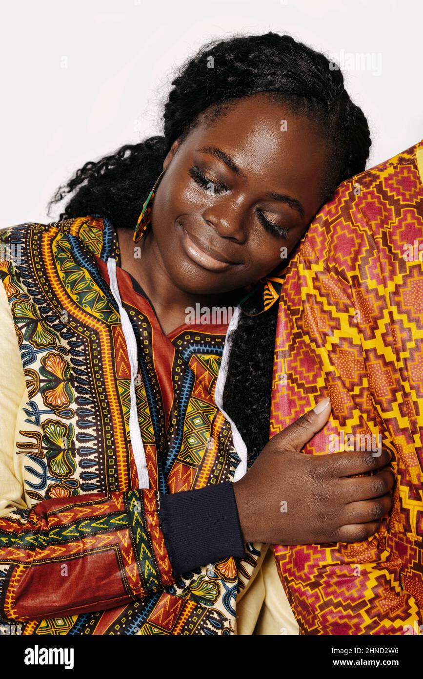 Dreamy Curvy Woman In Traditional African Clothes Hugging An Anonymous