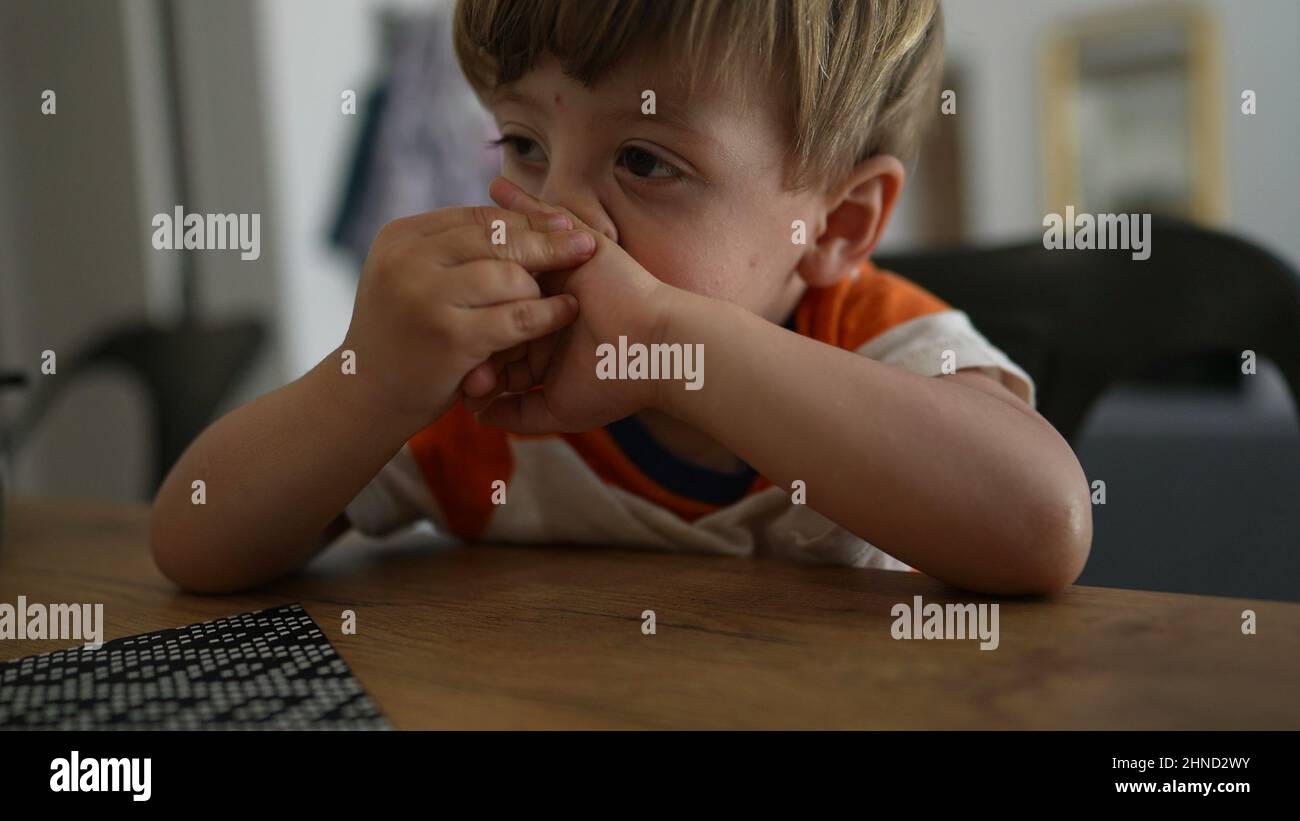 Child rubbing face and nose with hands Stock Photo - Alamy