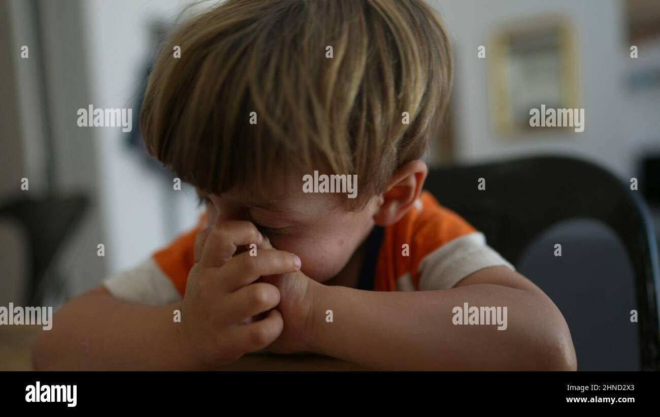 Child rubbing face and nose with hands Stock Photo - Alamy