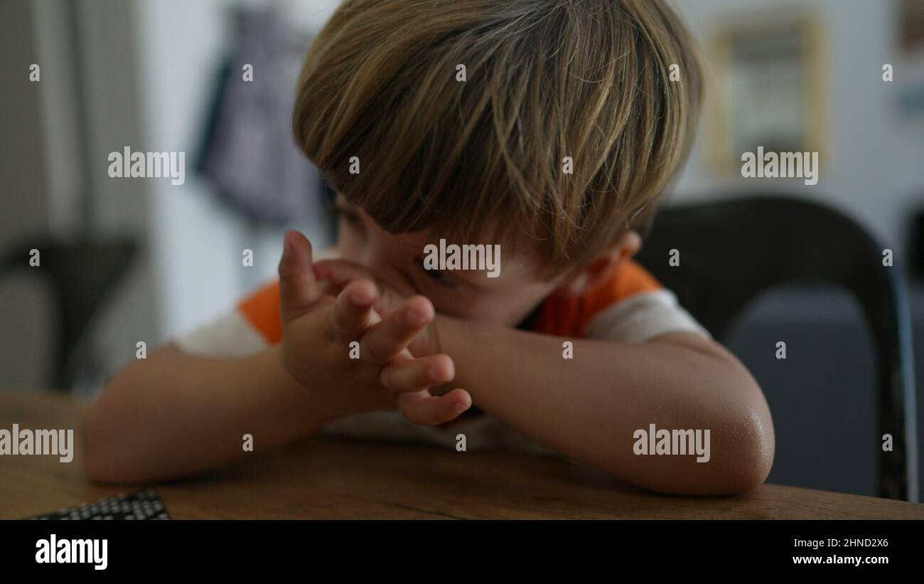 Child rubbing face and nose with hands Stock Photo - Alamy